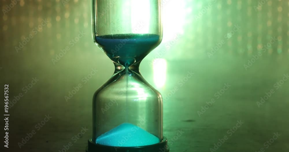 Time concept. Silhouette of Hourglass clock on dark toned backlight ...