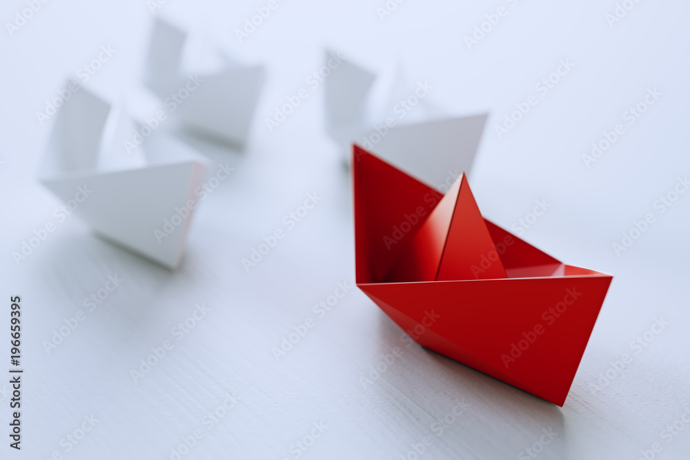 Leadership concept with red paper ship leading among white on white ...