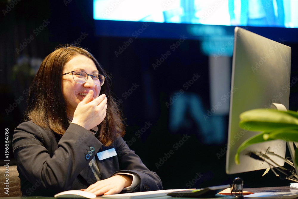 Hotel manager. A woman-reception shocked sitting in front of the ...