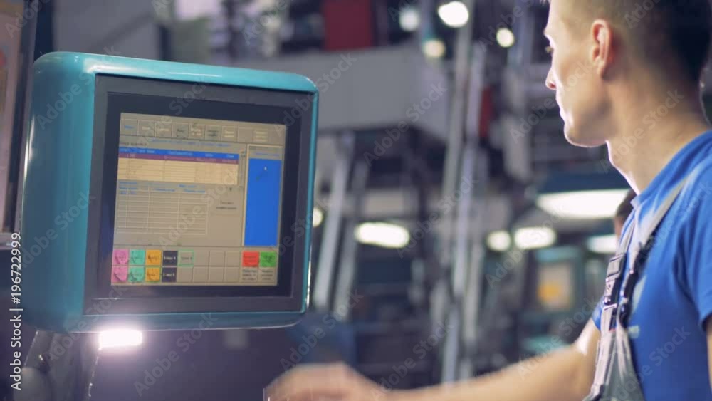 Engineer chooses factory equipment options using touchscreen of an ...