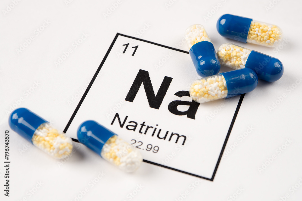 Pink pills with mineral Na (natrium) on a white background with an ...