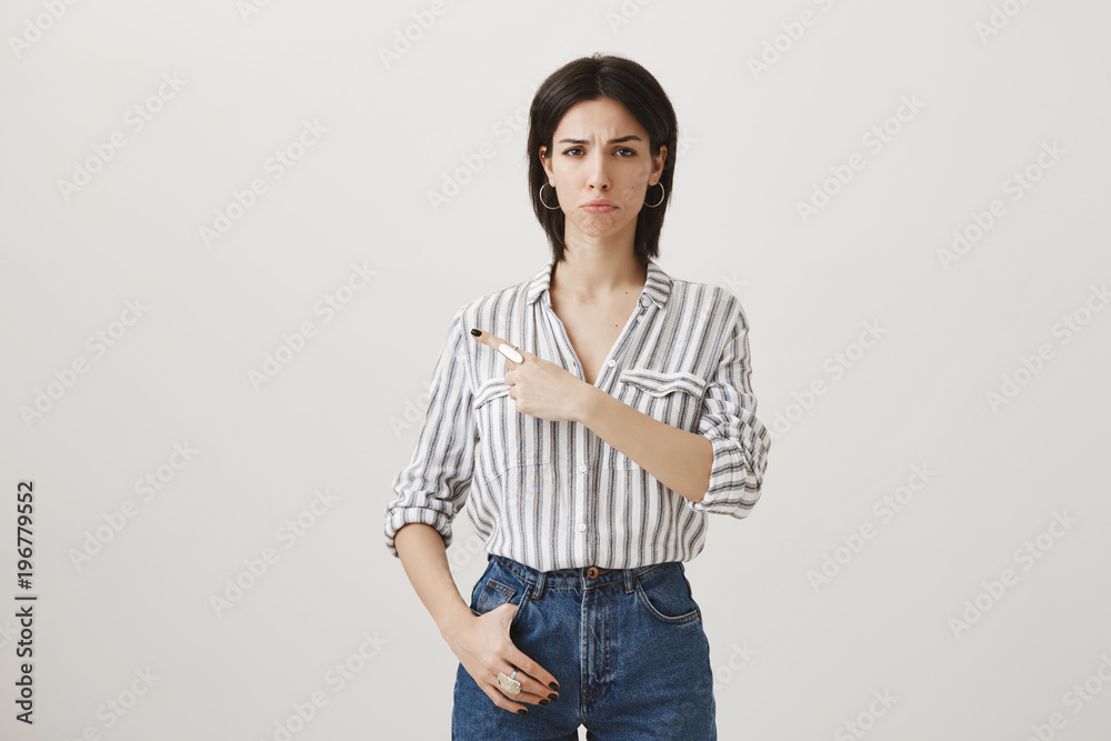 Girl indicates at person who made her mad and upset. Gloomy ...