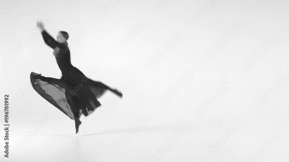 Black and white image. Young woman choreographer dancing in a black ...