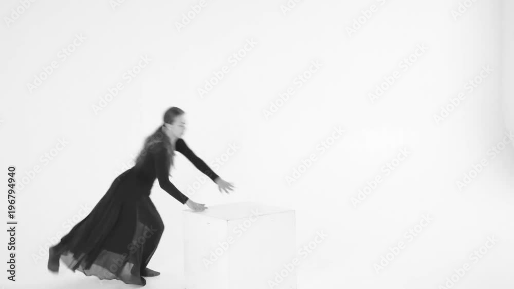Black and white image. Young woman choreographer dancing in a black ...