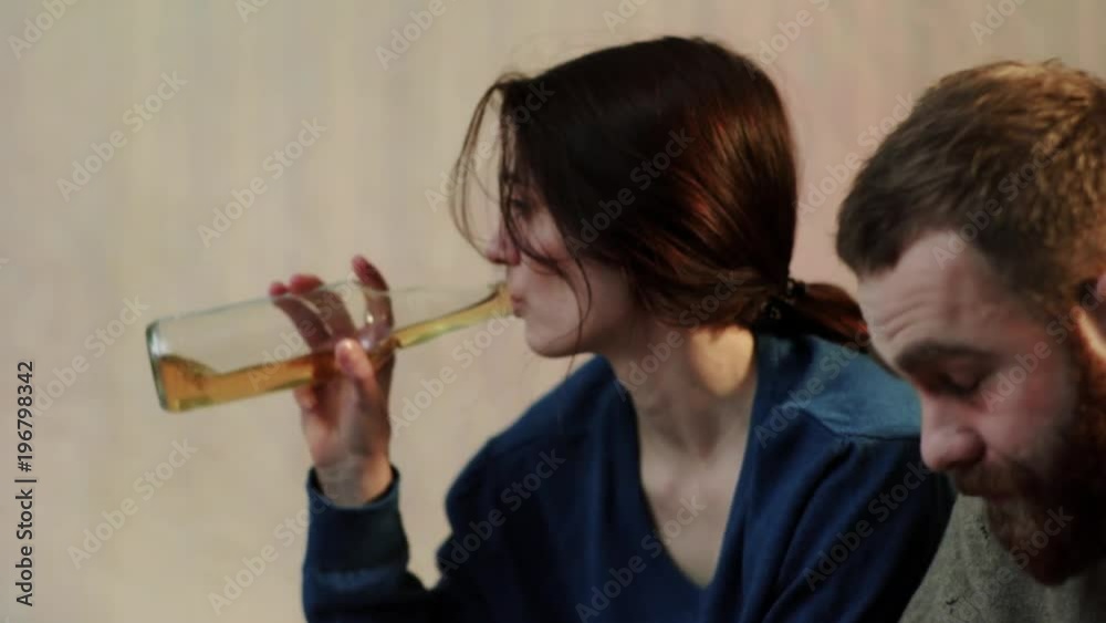 Video Stock Unhealthy drunk alcoholic man and woman with a beer sit on ...