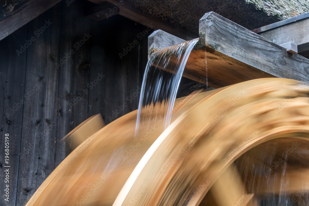 The part of mill wheel rotates under a stream of water, open air museum ...