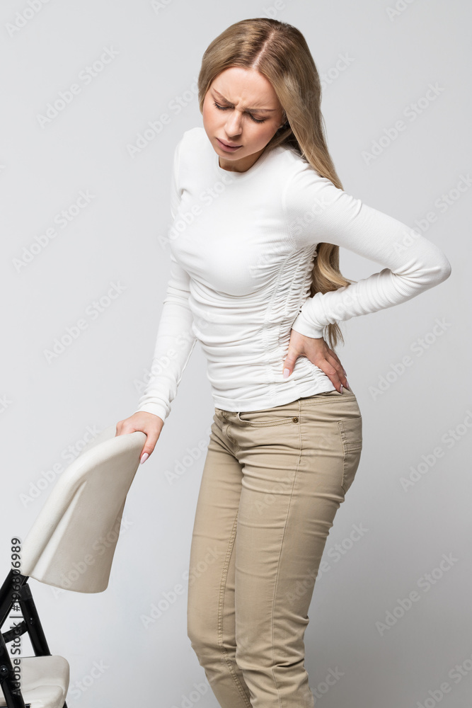 Woman having pain, muscle or chronic nerve pain in her back, hold the ...