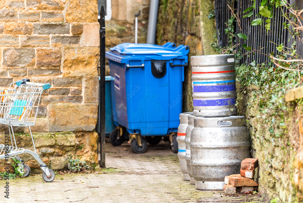 Day view of stacked beer casks of kegs at the back of the pub with ...