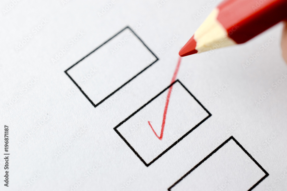 Marker puts a tick in the box on white paper Stock Photo | Adobe Stock