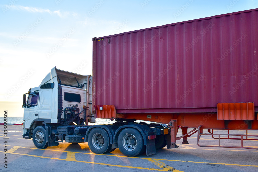 Heavy duty truck pick up shipping container at port. Logistics concept ...