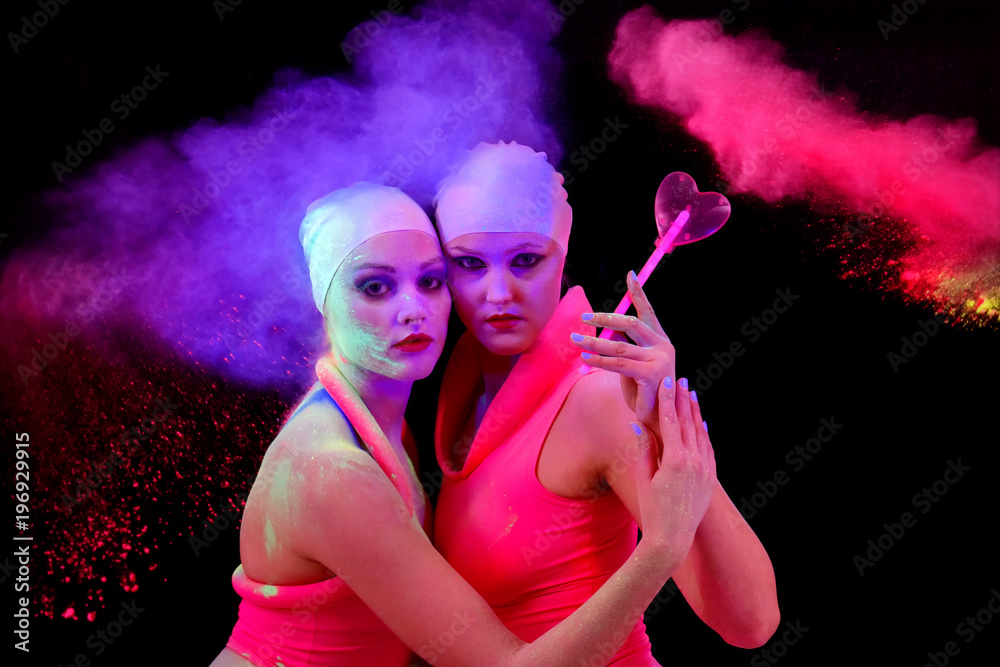 Two beautiful girl feel an affection for each other. They embrace ...