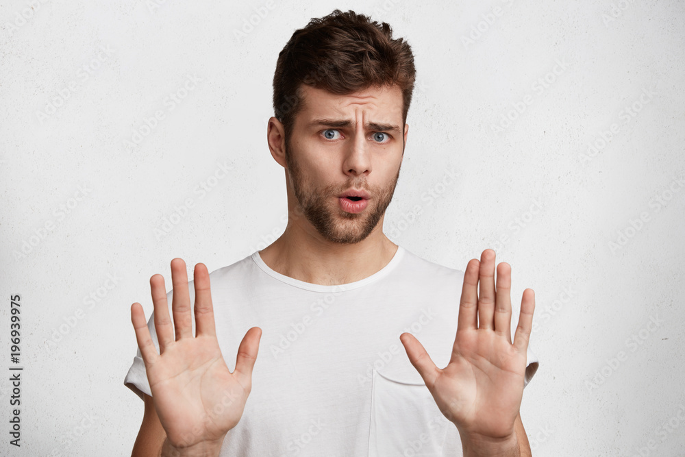 Attractive Brunet Male Shows Refusal Gesture Doesn`t Want To