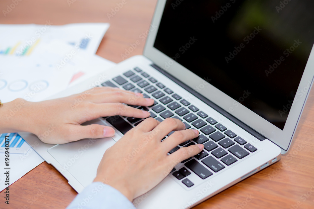 Closeup work with finance analysis and planing data on laptop, typing ...