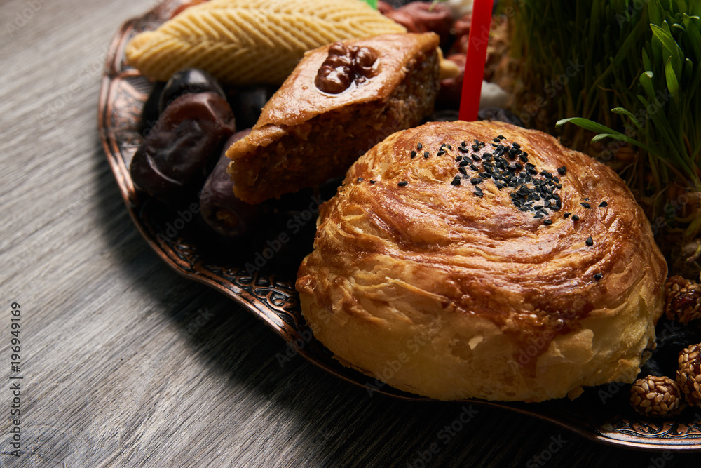 Shekerbura, pakhlava and gogal pastry, with dry fruits on novruz tray ...