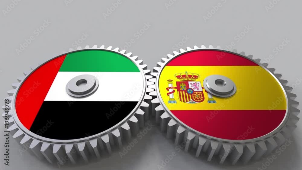 Flags of the UAE and Spain on meshing gears. International cooperation ...