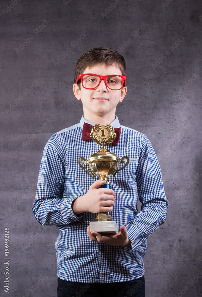 Little boy celebrates his golden trophy Stock Photo | Adobe Stock