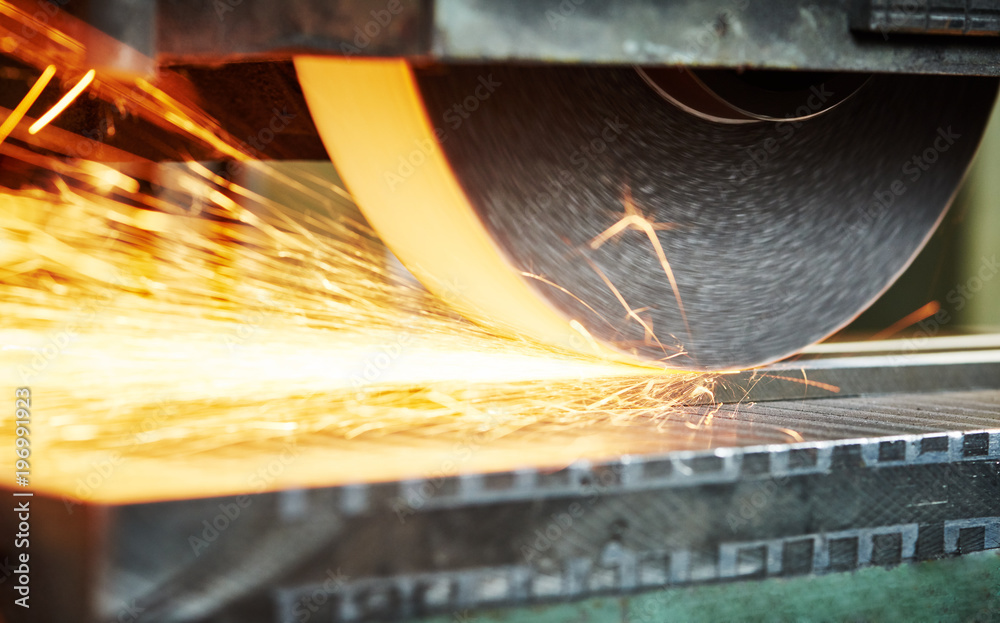industrial grinding. finishing metal surface on horizontal grinder ...