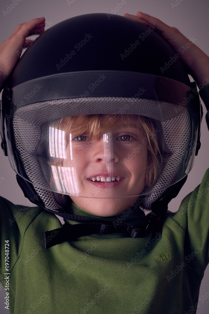 Cute boy in motorcycle helmet Stock Photo | Adobe Stock