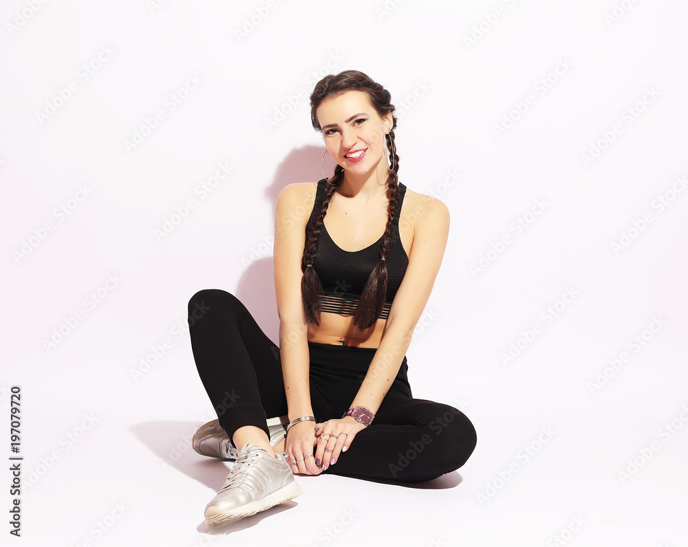 Full body portrait of a female fashion model sitting on white ...