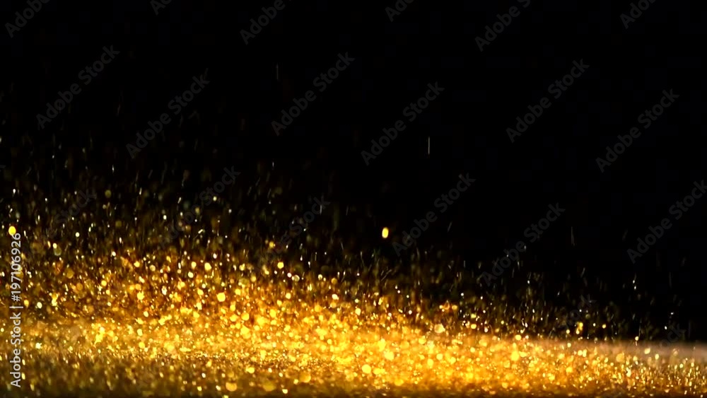 Glitter exploding golden sparkles isolated on black background ...