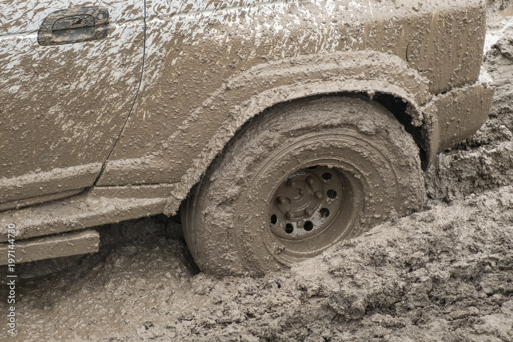 The wheels of the car are soiled in mud and equipped for off-road ...