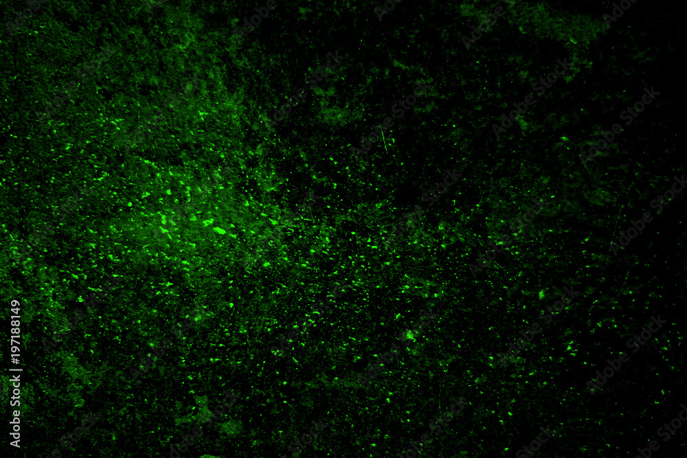 Abstract green background. Colored dust and powder explosion. Grainy ...