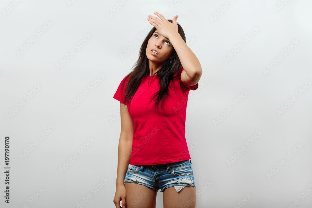 Young, beautiful girl makes a gesture Facepalm. Isolated on a light ...