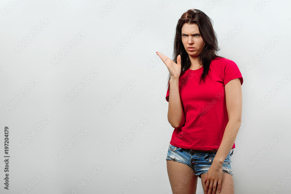 Young, beautiful girl waving her hand, bad smell. Isolated on a light ...