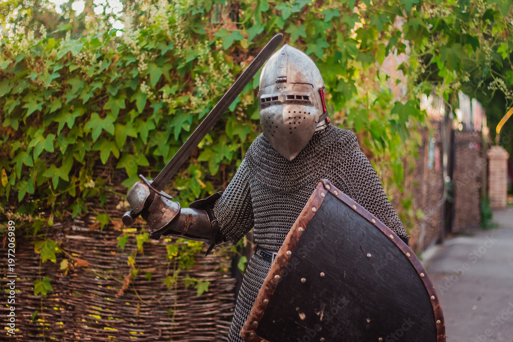 A man with a gun, a stern look. Knight in armor in the castle. Medieval ...