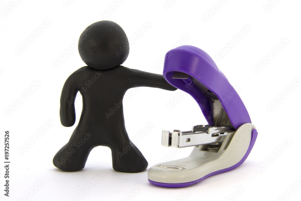 Black plasticine characters and stapler. Stationery. Isolated on white ...