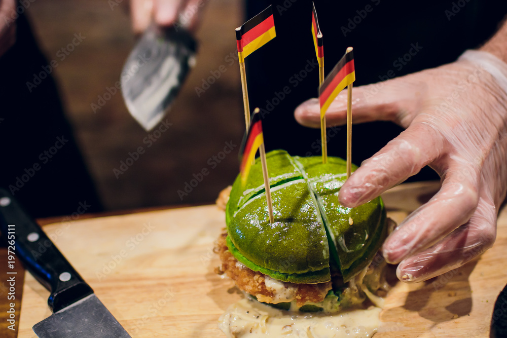 Chief cook preparing fresh burger in the kitchen.Burger restaurant menu ...