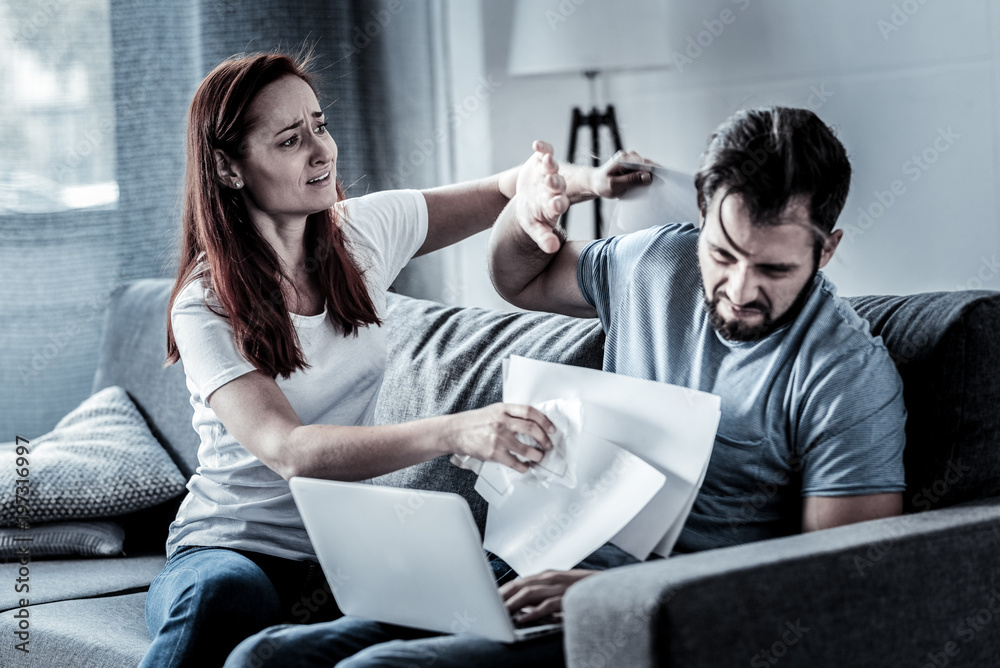 Its because of you. Stressful young worried woman sitting on the sofa ...