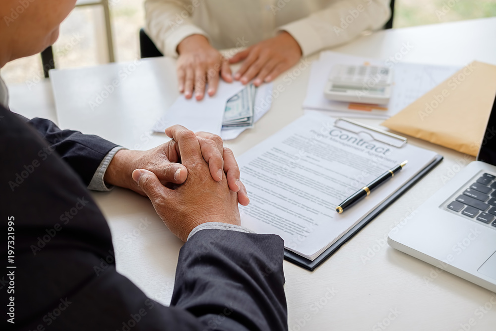 Businessman giving money while making deal to agreement a real estate ...