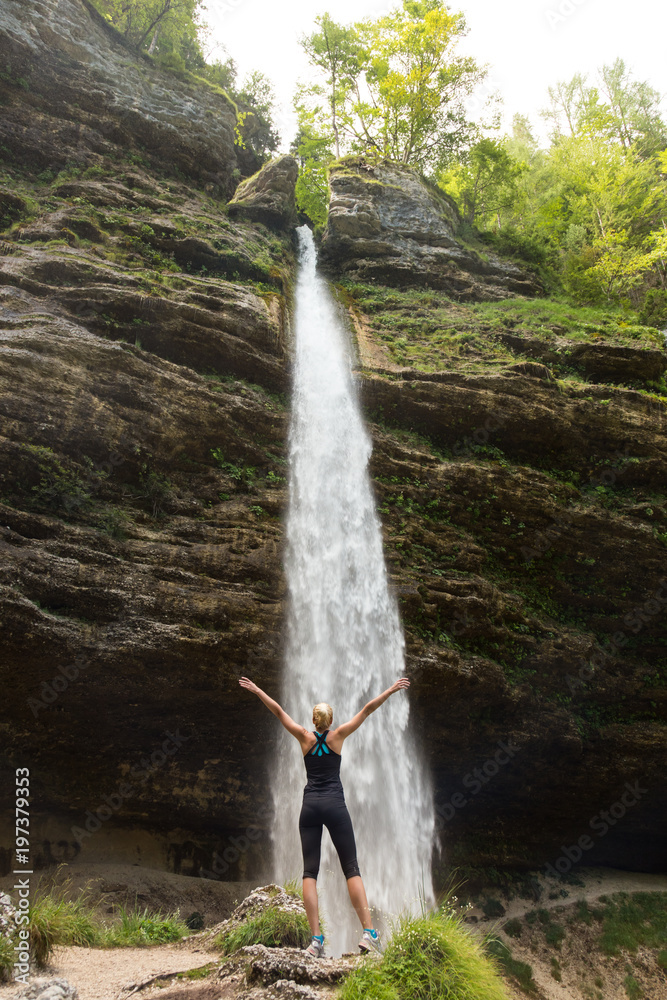 Active woman raising arms inhaling fresh air, feeling relaxed and free ...