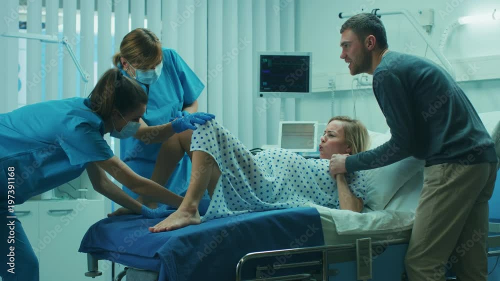 In the Hospital, Woman in Labor Gives Birth, Obstetricians and Doctors ...