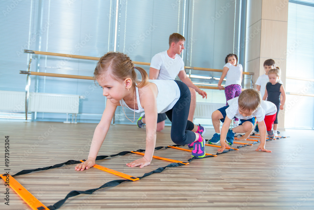 Happy sporty children in gym. Kids exercises Stock Photo | Adobe Stock