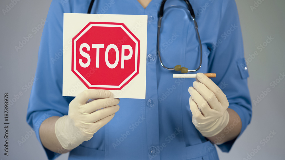 Hospital nurse holding stop sign and cigarette, preventing unhealthy ...