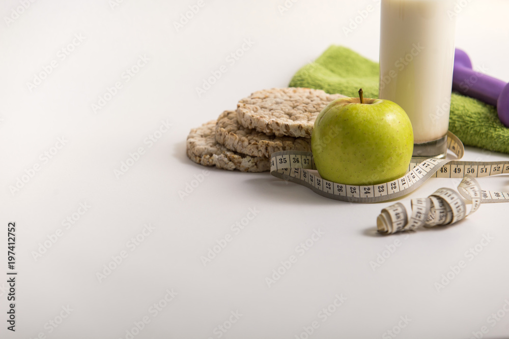 proper nutrition, fitness food, a glass of water, a green apple, wheat ...