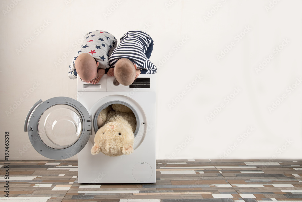 Parents bought a new washing machine. The children try to turn it on ...