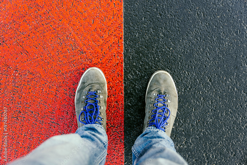 Concept of facing a crucial decision shown by shoes on different ...