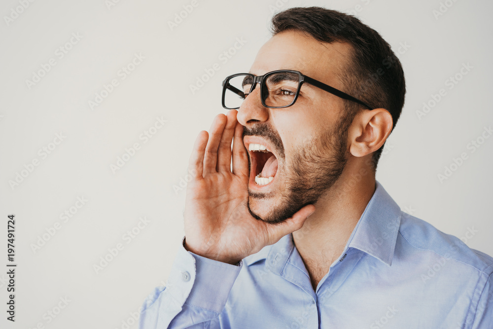 Attractive Man Cupping Hand and Shouting Loud Stock Photo | Adobe Stock