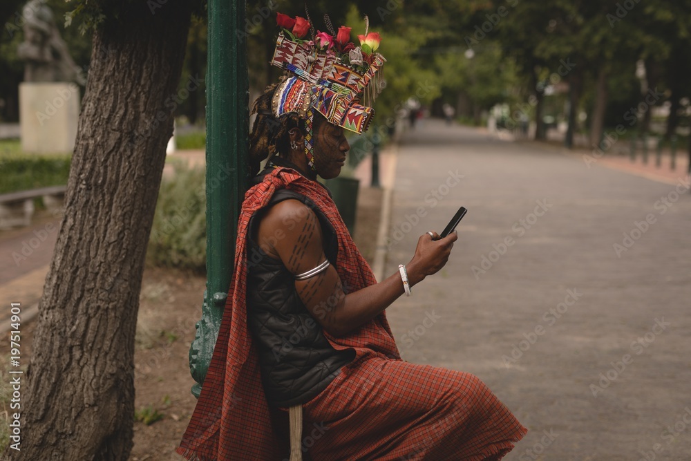 Maasai man in traditional clothing using mobile phone Stock Photo ...