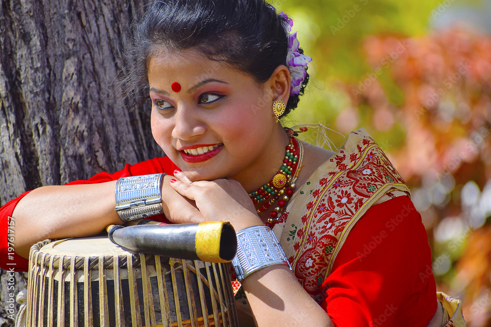 Assamese girl In traditional attire posing with A Dhol, Pune ...