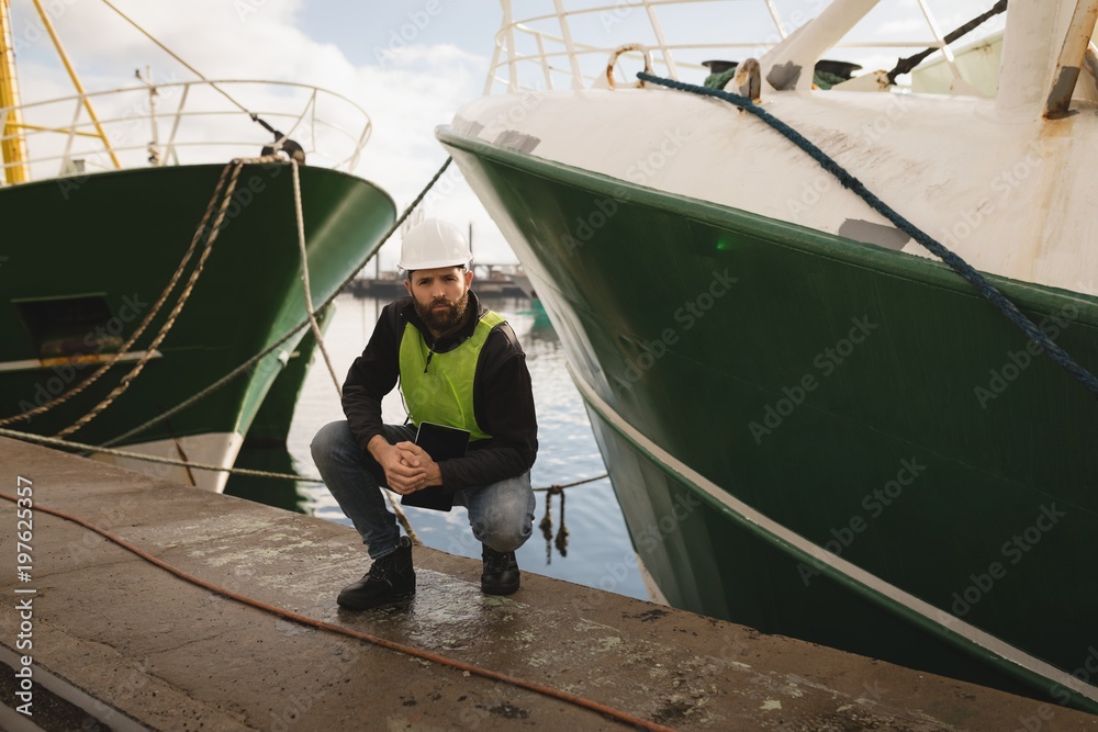 Dock worker posing near ship at port Stock Photo | Adobe Stock