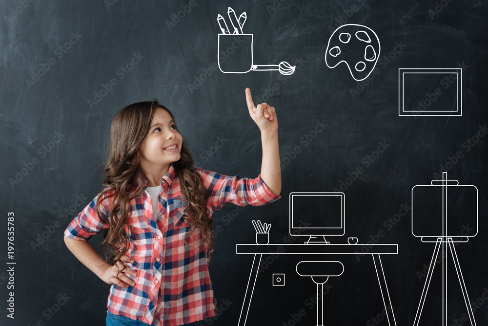 Creative child. Cute happy emotional girl pointing her finger up and ...