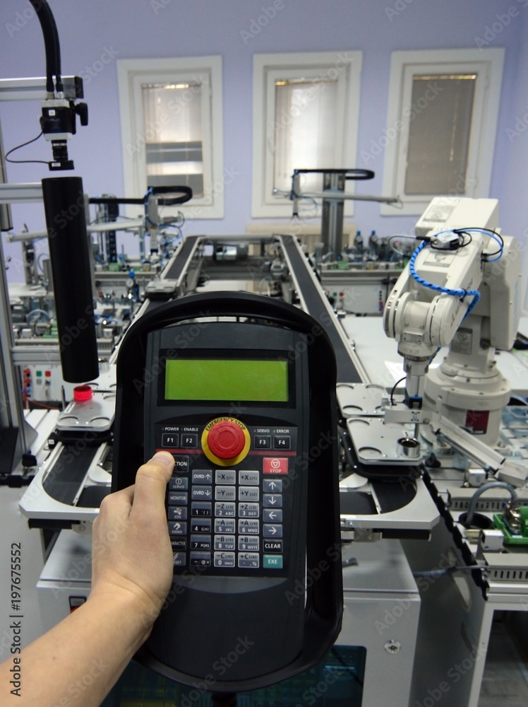 Focus on control panel. Male hand is holding the control panel of the ...