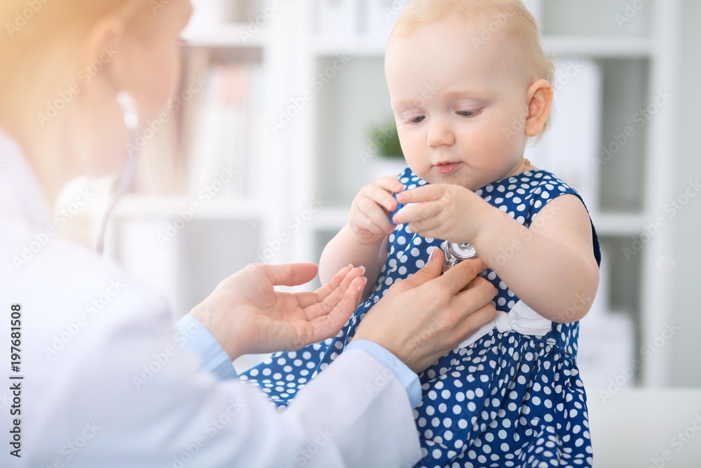 Pediatrician is taking care of baby in hospital. Little girl is being ...