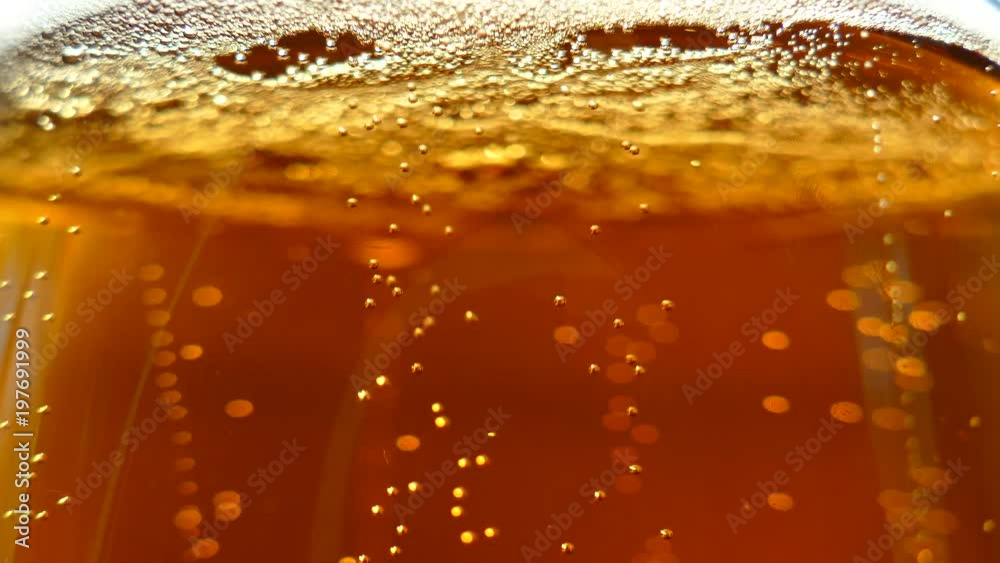 Beer is poured into a glass glass. Light, low-alcohol beverage of ...