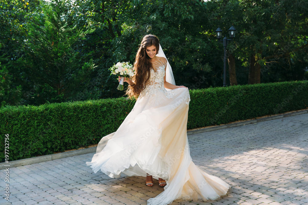 Beautiful bride with wedding flowers bouquet, attractive woman in ...