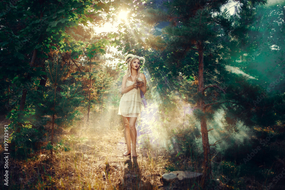 Beautiful model is posing in a forest with white horns Stock Photo ...
